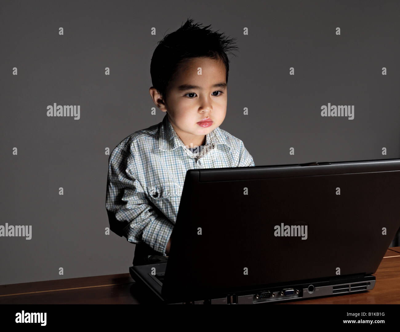 Half-asian boy using laptop Stock Photo - Alamy