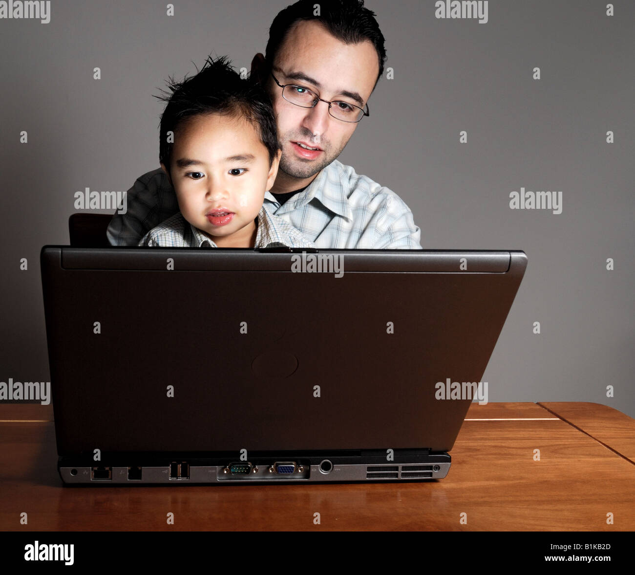 Father and son using a laptop Stock Photo - Alamy