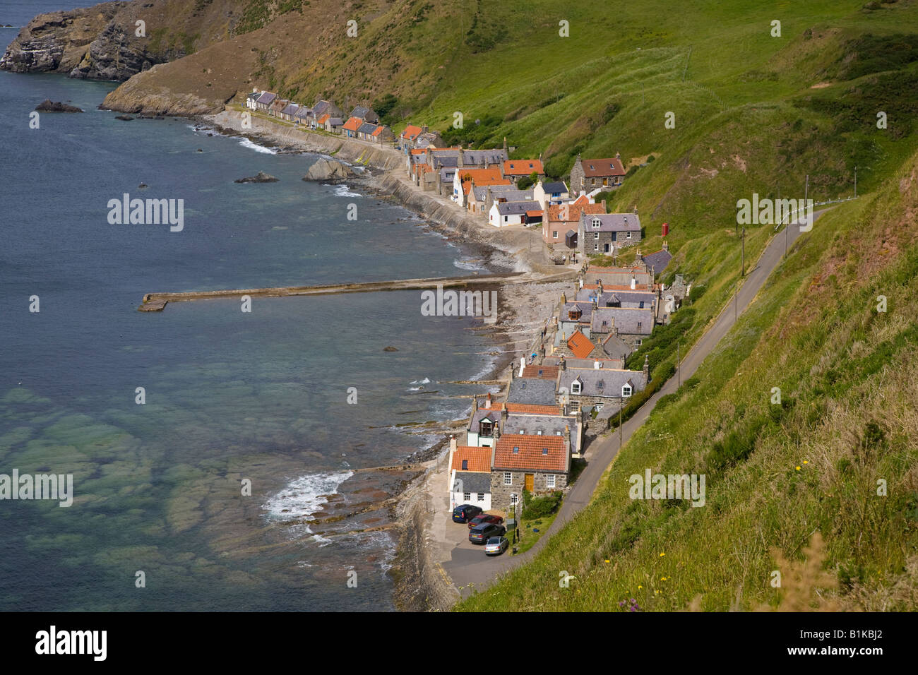 Looking down on Scottish rural houses & rooftops at the seaside coastal ...