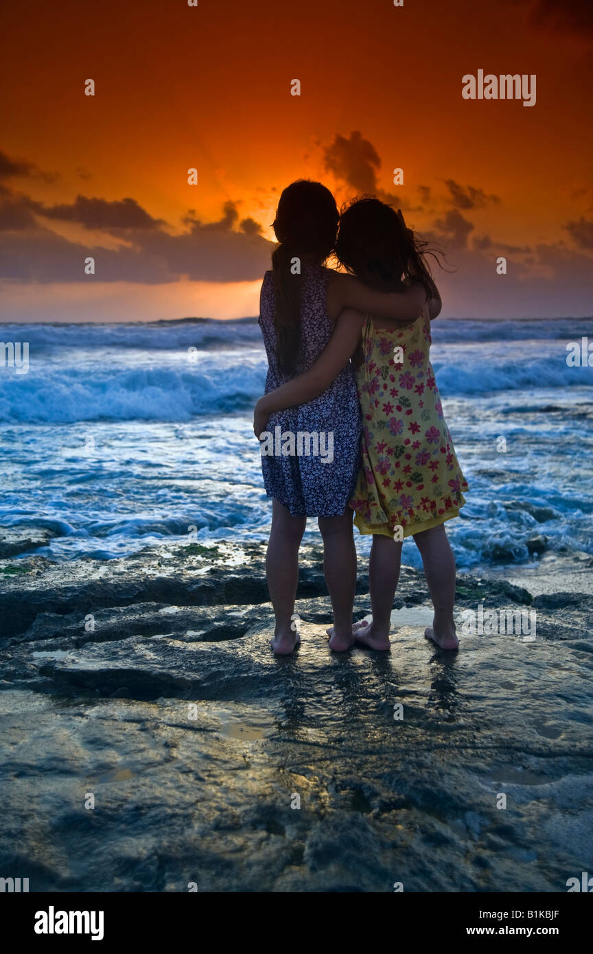 two girls in the beach at sunset Stock Photo - Alamy