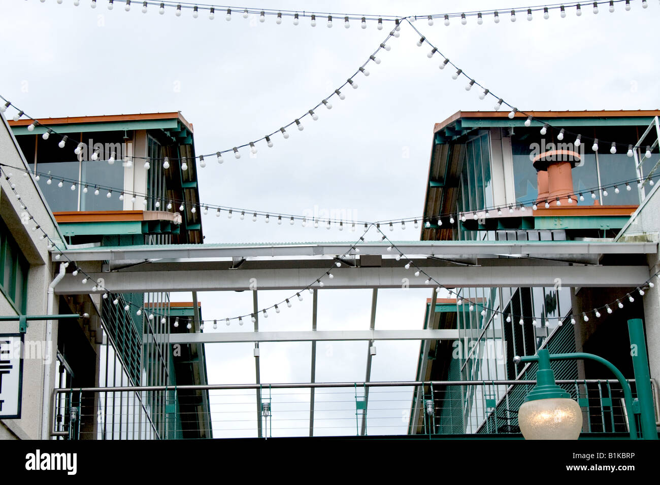 Strings of patterned lights hanging from two buildings Stock Photo - Alamy