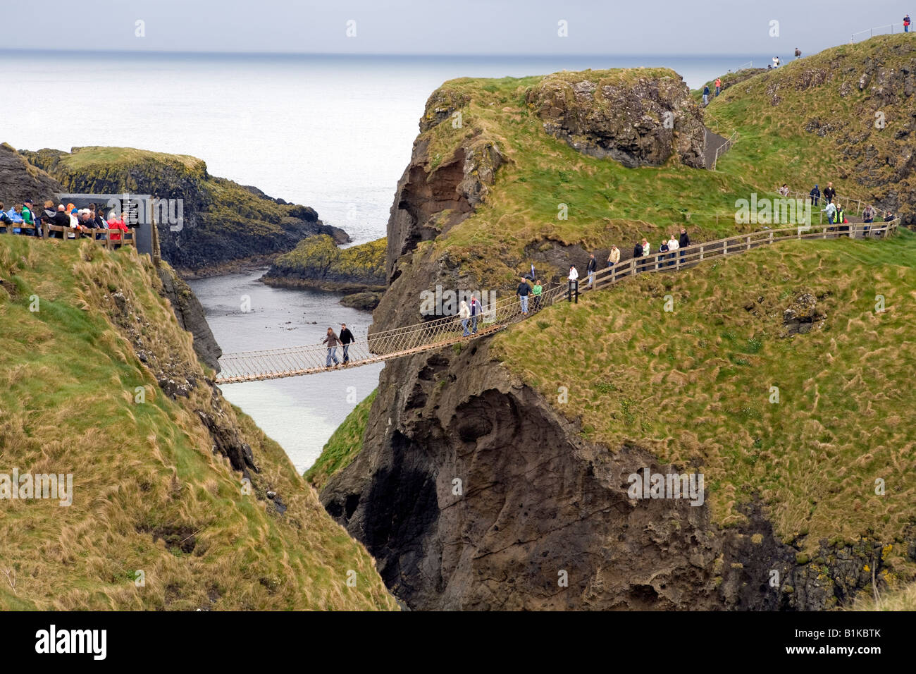 Cliff rope bridge sea tourists hi-res stock photography and images - Alamy