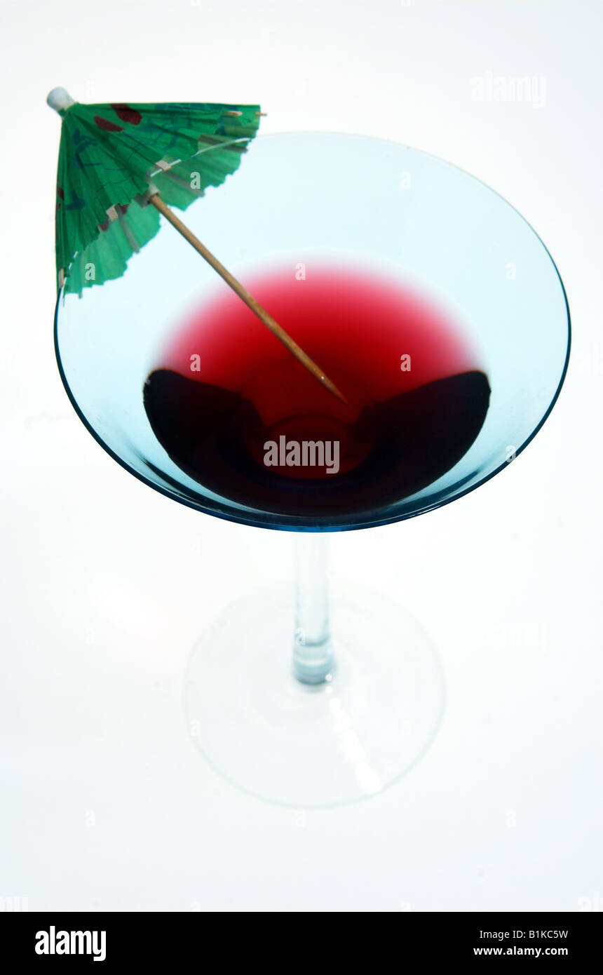 overhead of cocktail in blue glass with fun umbrella Stock Photo - Alamy