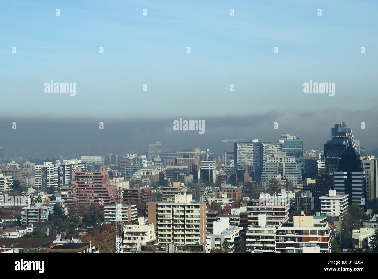 A thick layer of smog hangs over central Santiago, Chile. This type of ...