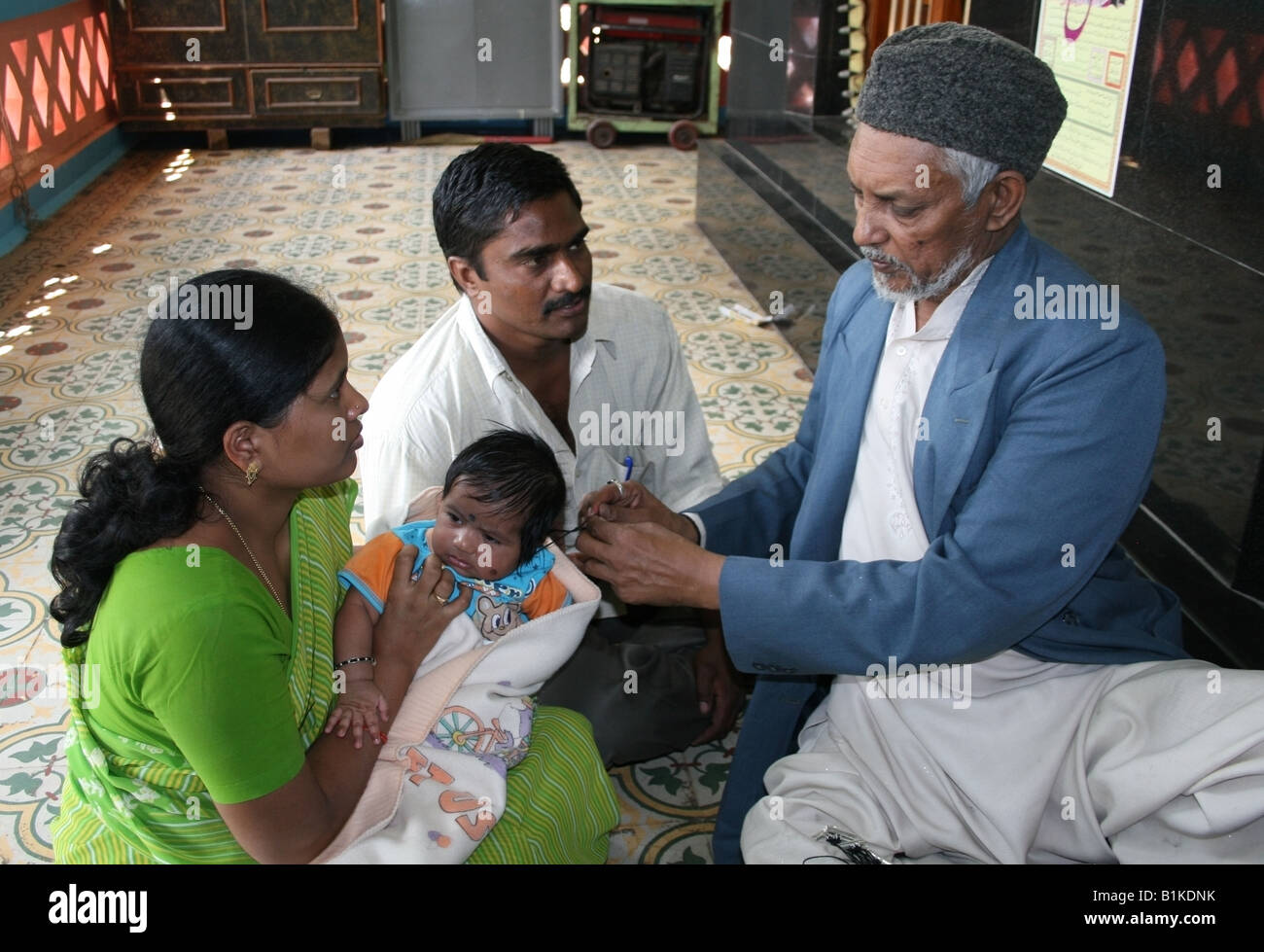 A Hindu family gets their child blessed by a Muslim Iman at the tomb or ...