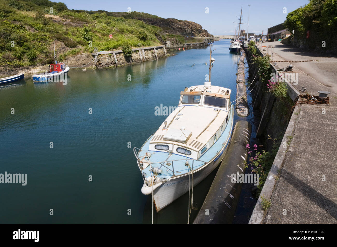 Amlwch Anglesey North Wales UK June Moored boats by wharf in old port ...