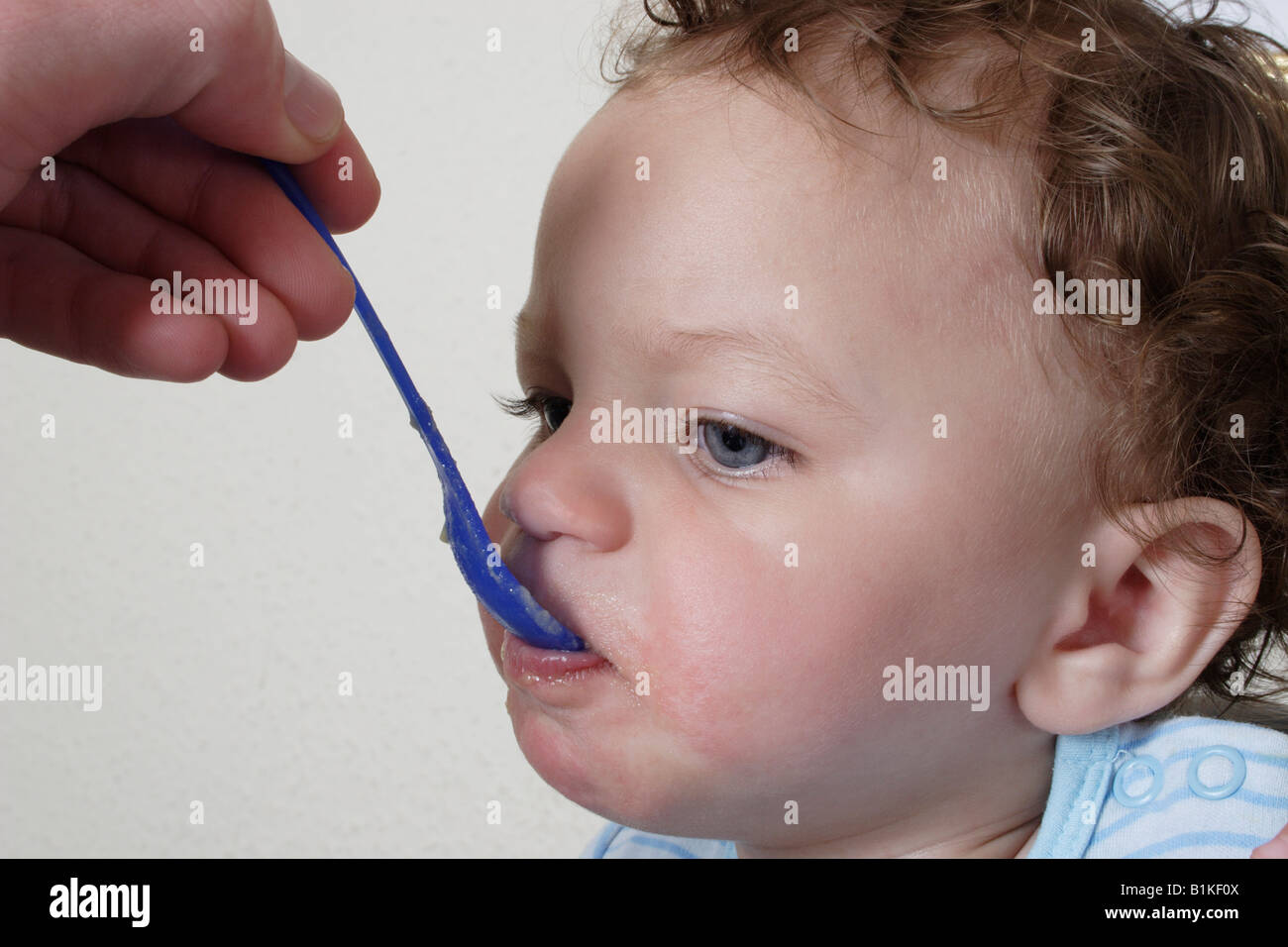 little baby being spoonfed Stock Photo - Alamy