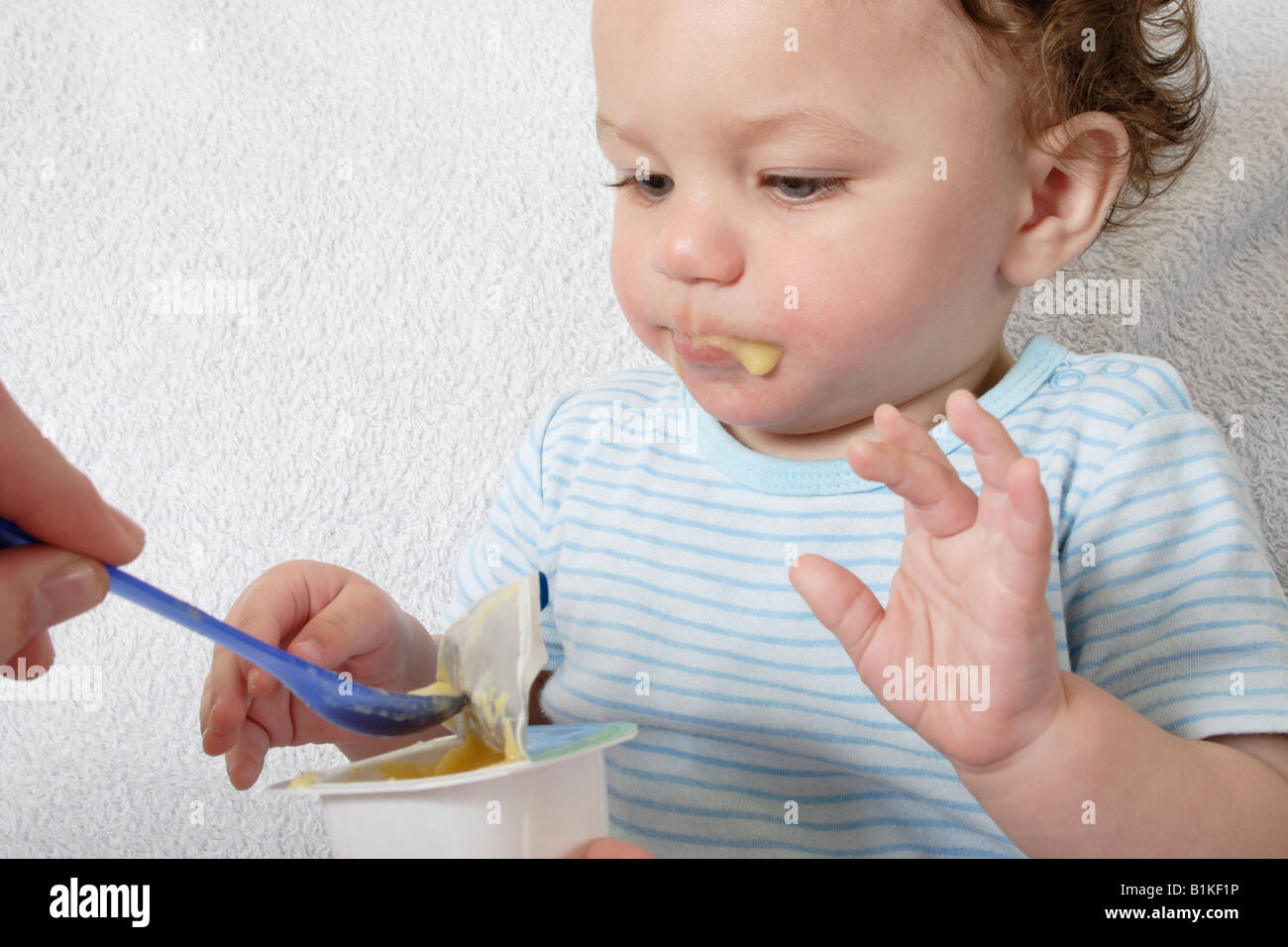 Baby eating off spoon hi-res stock photography and images - Alamy