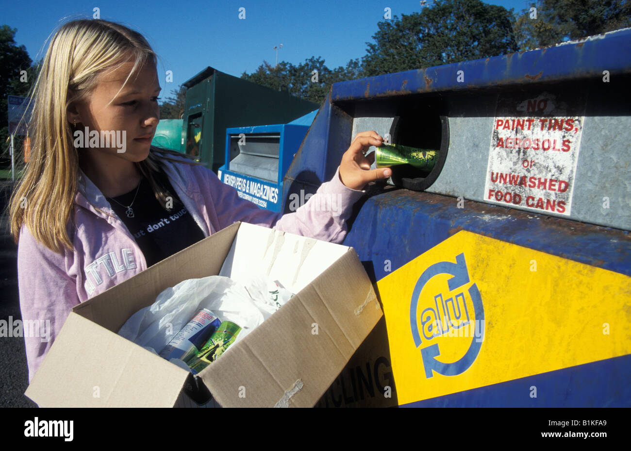 teenage girl putting aluminium canss in reycling bins Stock Photo - Alamy