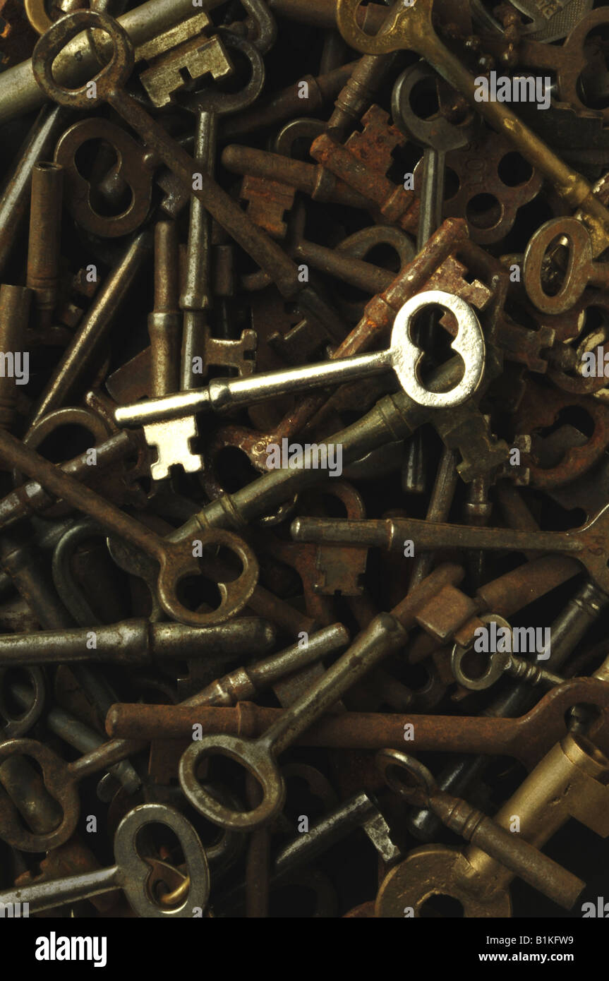 A shiny new skeleton key among a pile of old rusted antique keys Stock ...