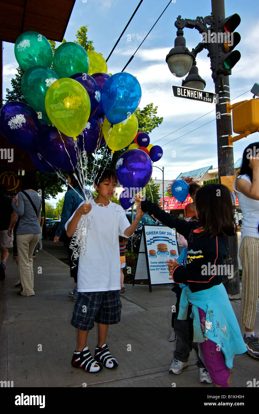 Boy volunteer handing out free helium filled balloons at the Vancouver ...