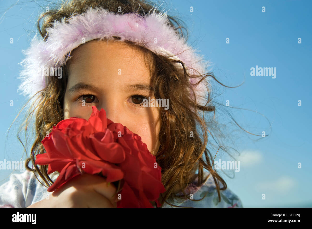 closeup of a crying little girl holding roses Stock Photo - Alamy
