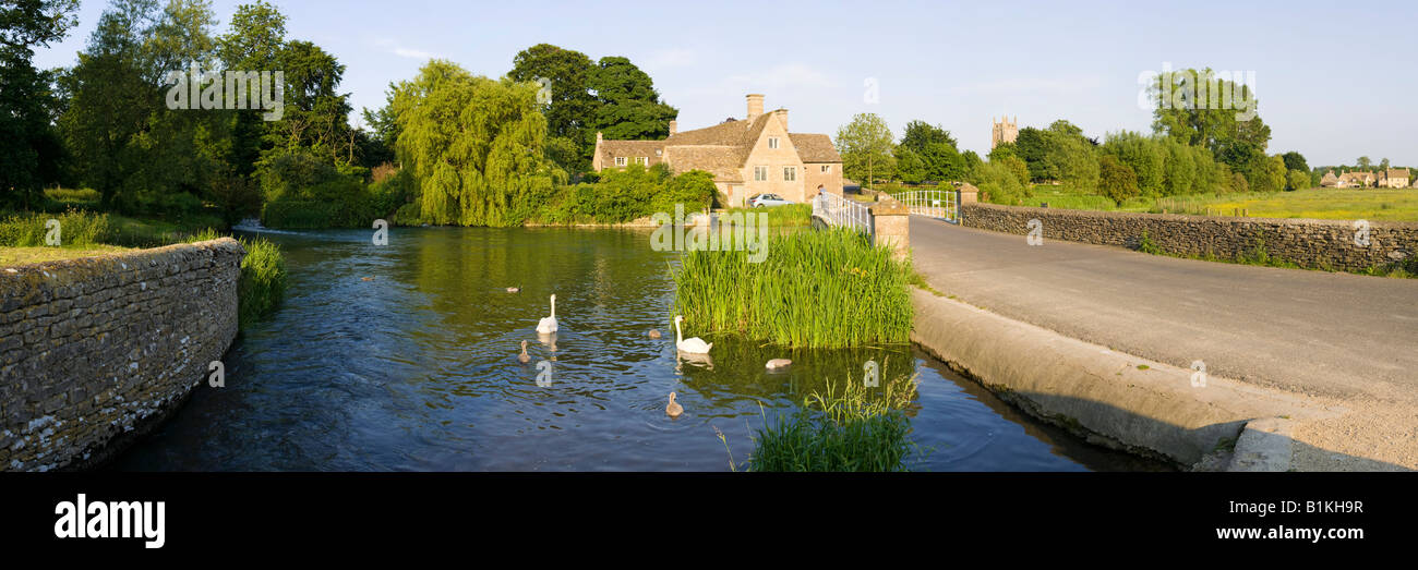 Evening sunlight on the River Coln at the Cotswold town of Fairford ...