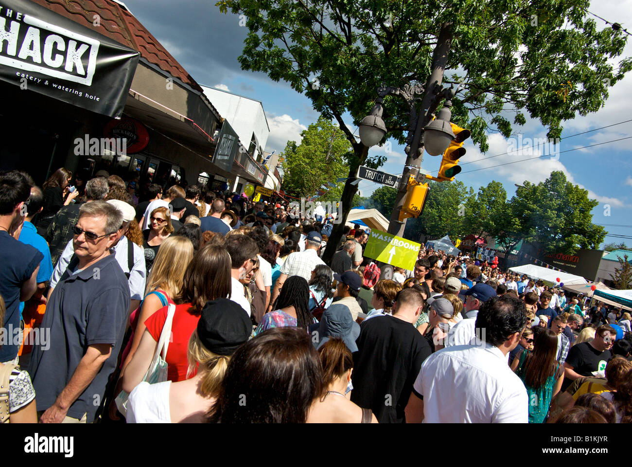 Massive crowd of people pack the city street and sidewalk at the ...