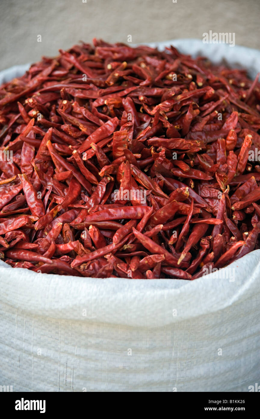 red hot chilli peppers in a sack in the market Stock Photo - Alamy