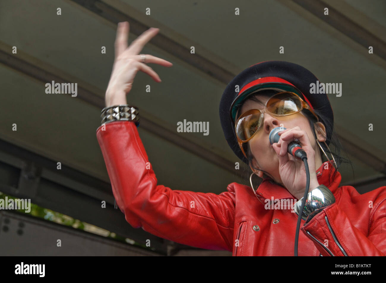 Singer in red leather jacket and peaked cap with red band at start of ...