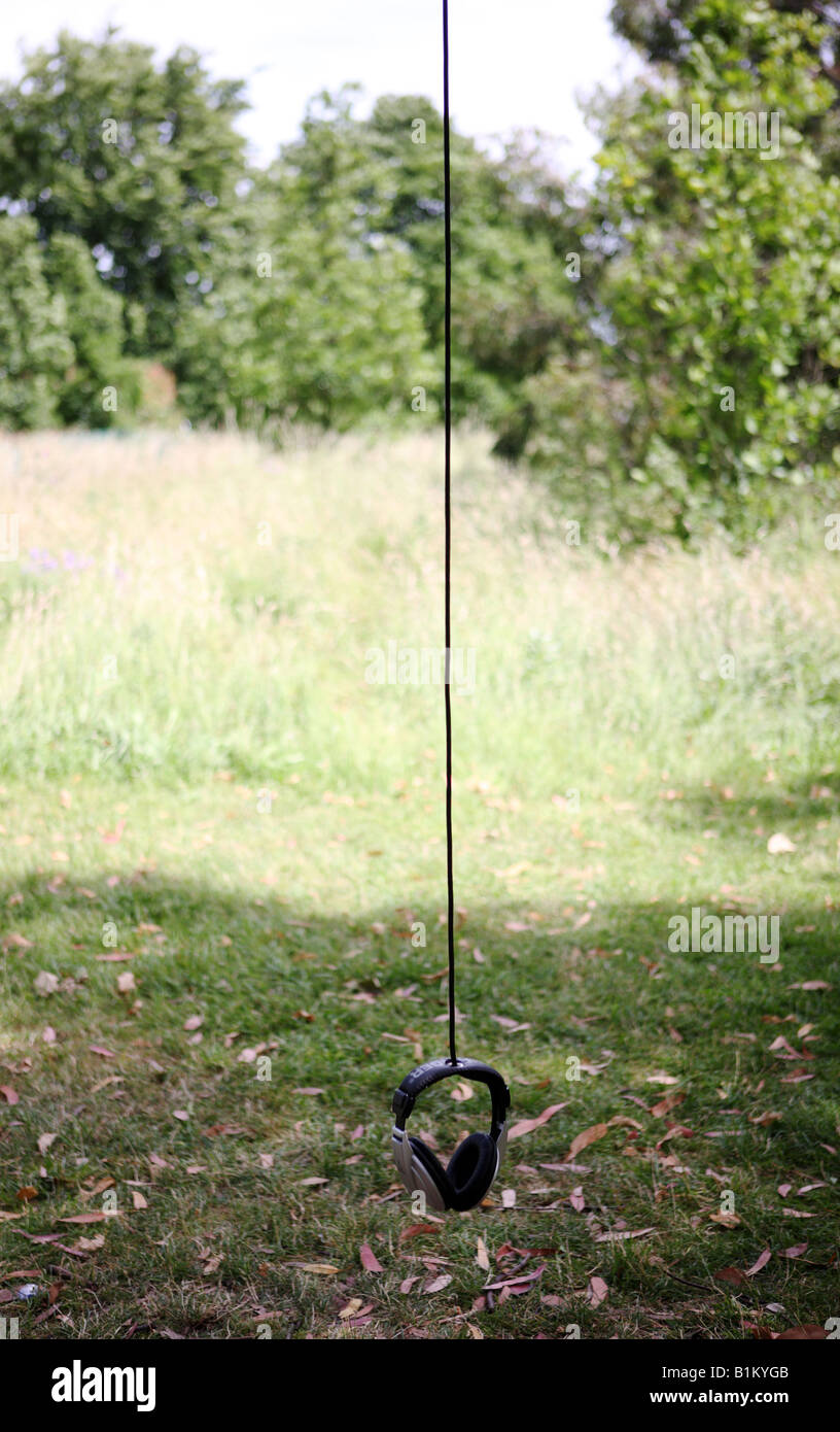 Headphones dangling from a tree, from tree listening exhibit Stock ...