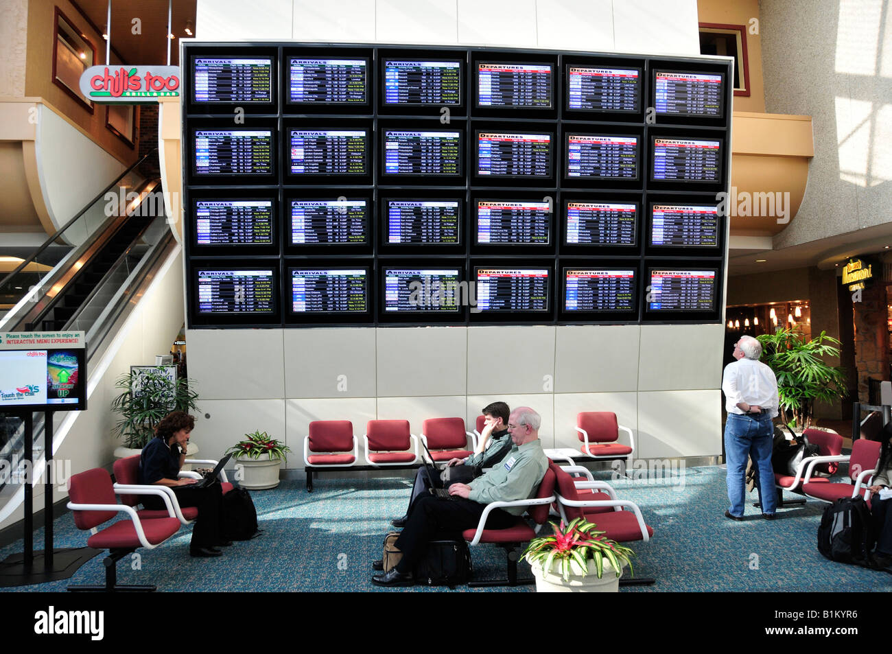 Waiting area Orlando International Airport showing arrivals and ...
