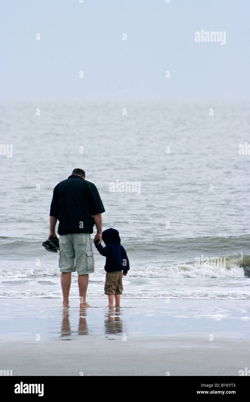 Father and son stand on the Atlantic Ocean Stock Photo - Alamy