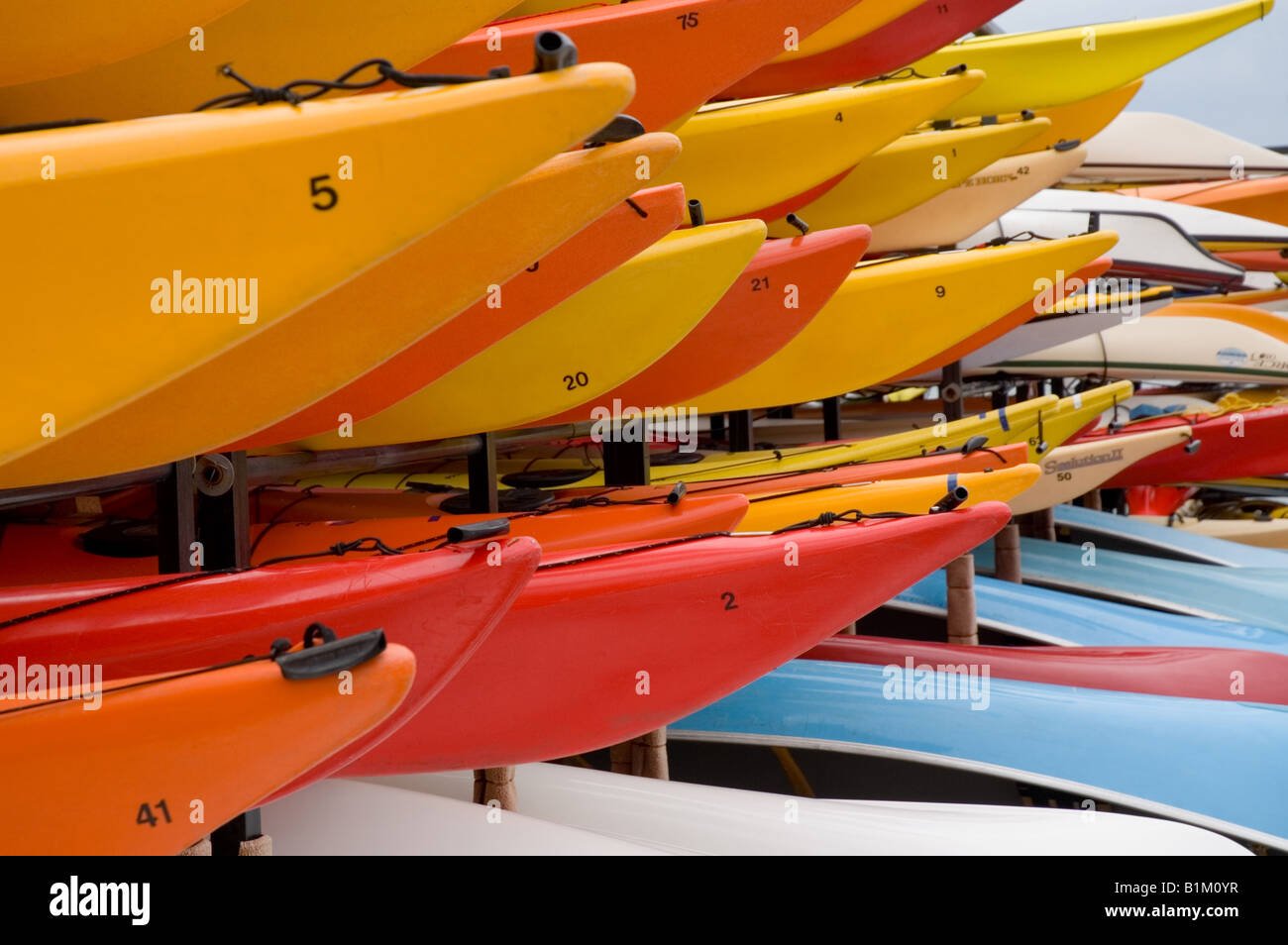 Kayaks stacked on the dock waiting to be rented Stock Photo - Alamy