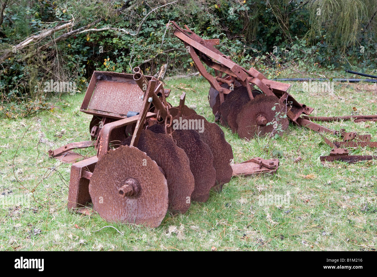An old plough left to rust in the corner of a farm field Stock Photo ...