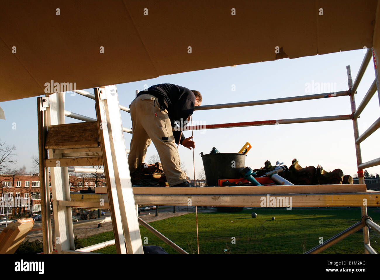construction worker on a scaffold Stock Photo - Alamy