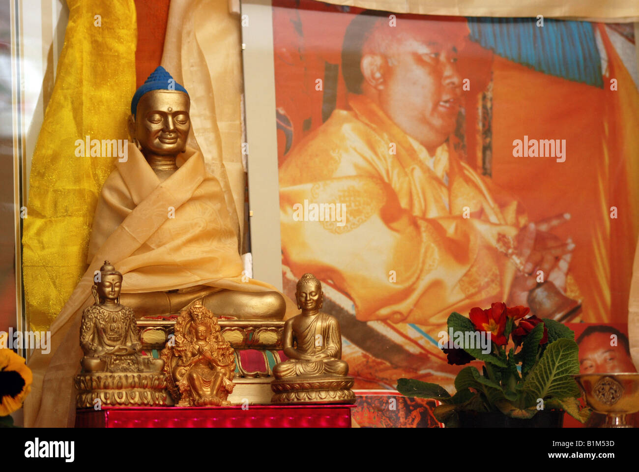 Three statues of Gautama Buddha (big one and smaller on the left and ...