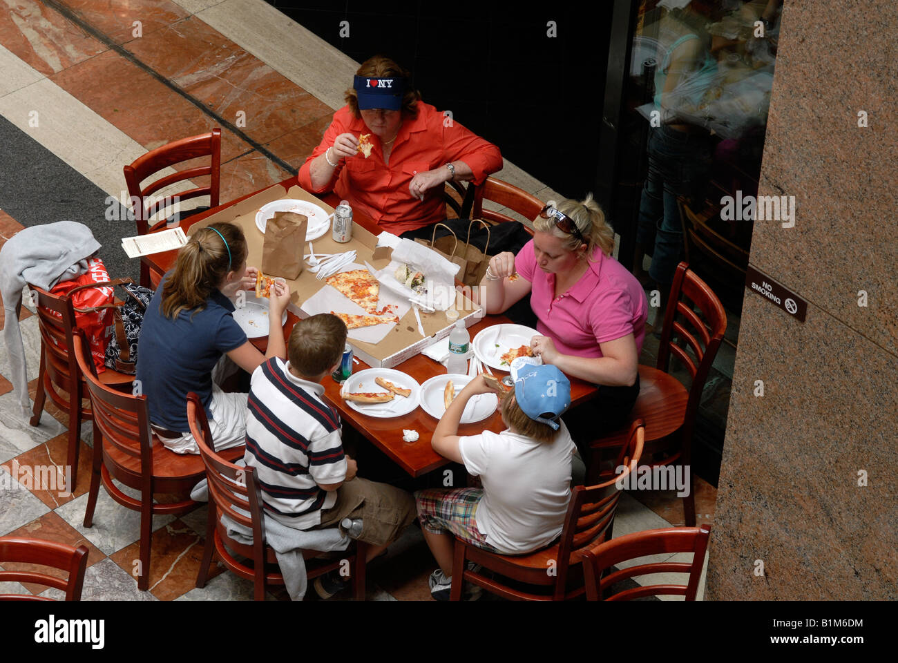 A family of tourists eats a lunch of gourmet pizza at the Donal Sacks ...