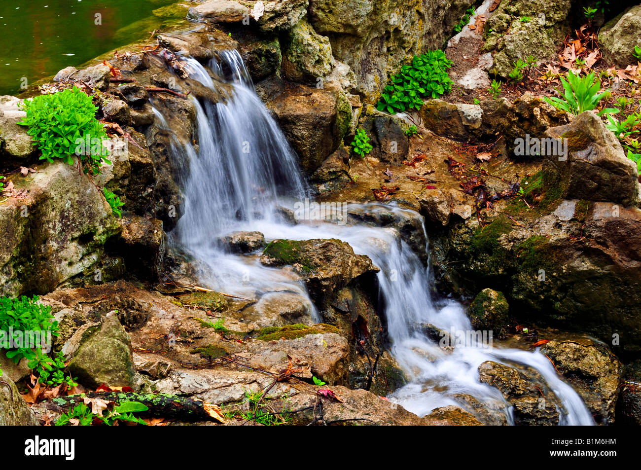 Cascading waterfall in japanese garden in springtime Stock Photo - Alamy