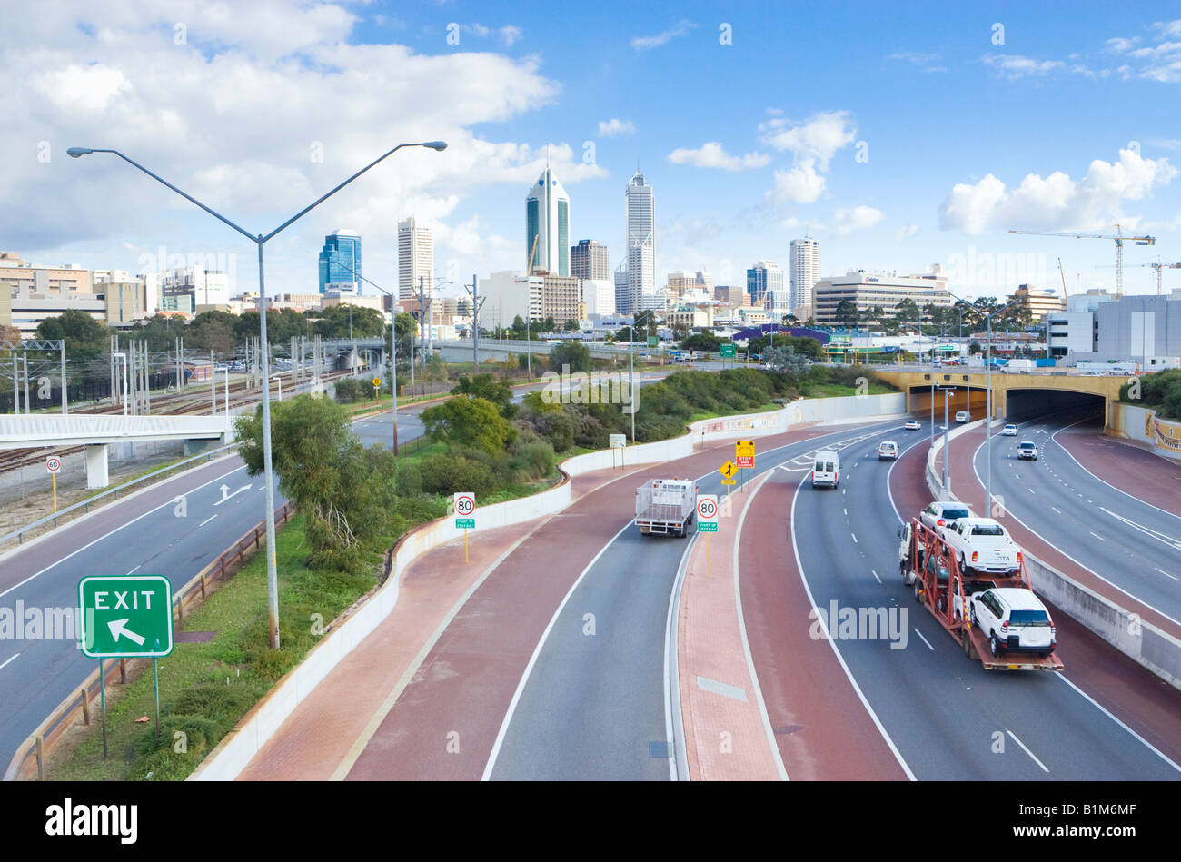 Traffic on the Graham Farmer Freeway in Perth with the city skyscrapers ...