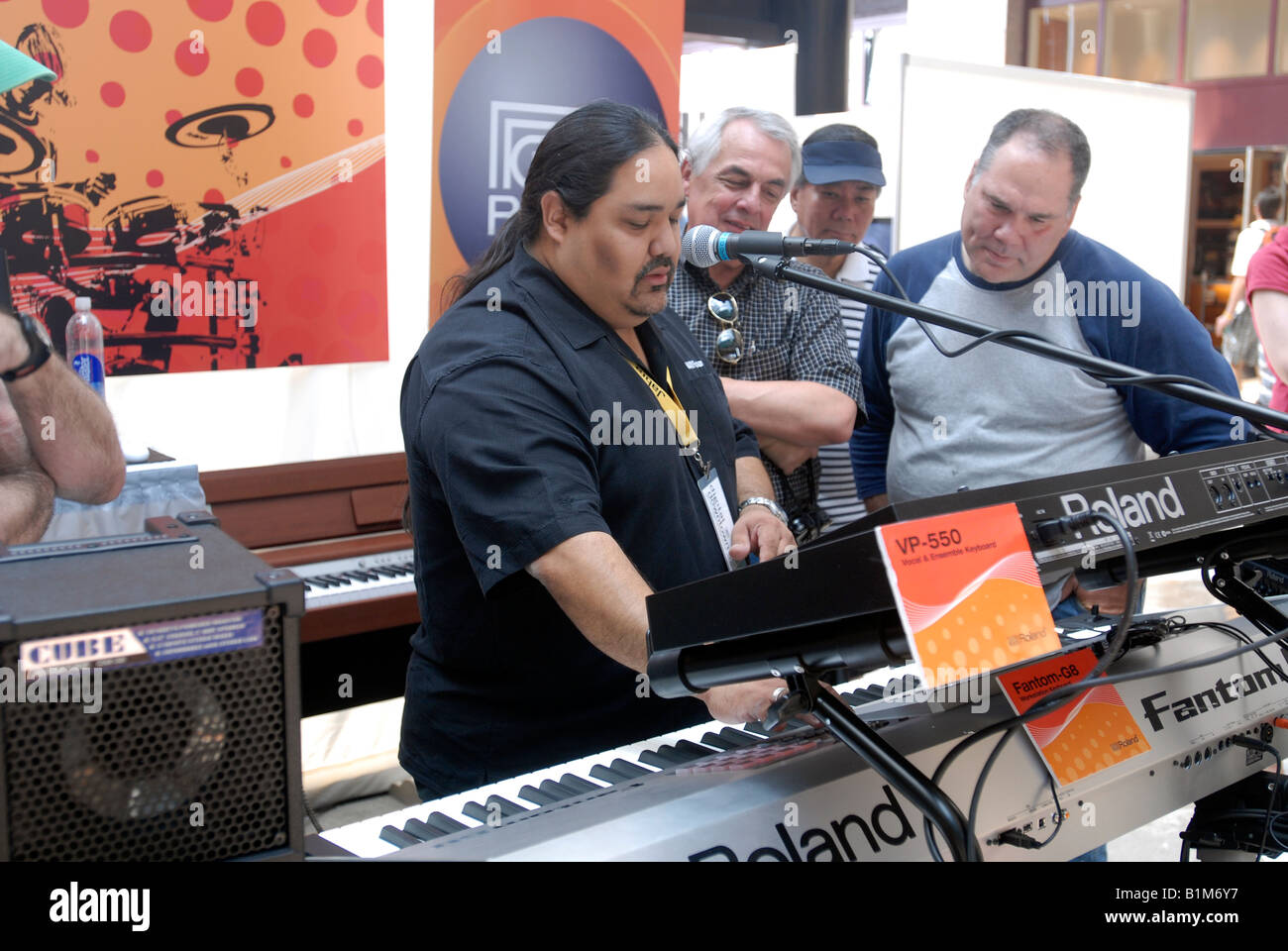 An employee of Roland demonstrates their keyboards at the World ...