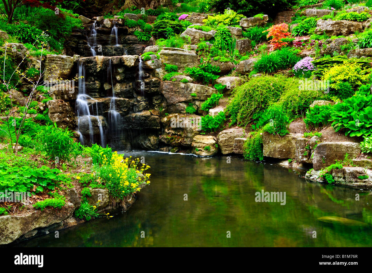 Cascading waterfall and pond in japanese garden Stock Photo - Alamy