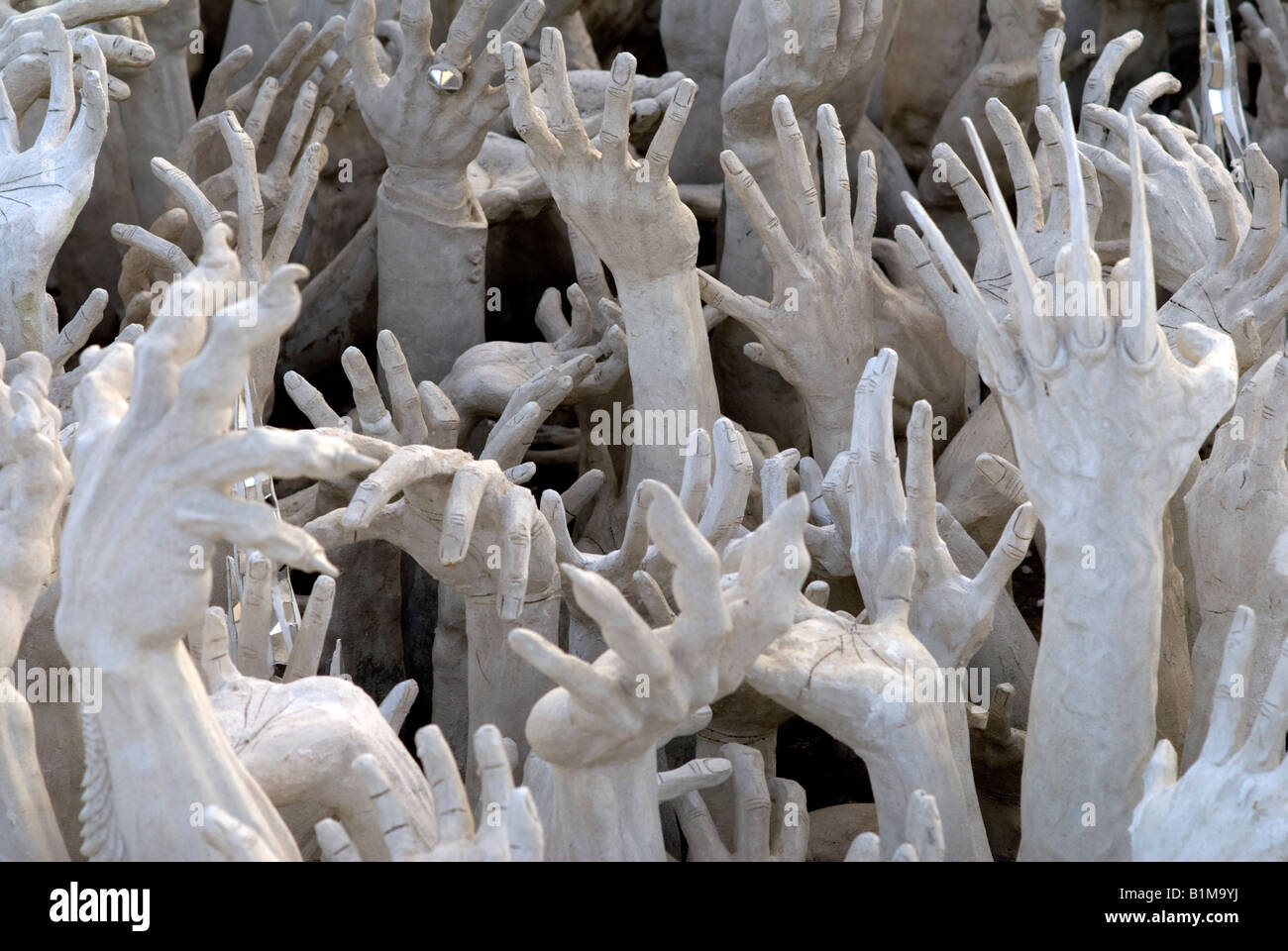 Concrete cement hands reaching up from the ground Stock Photo - Alamy