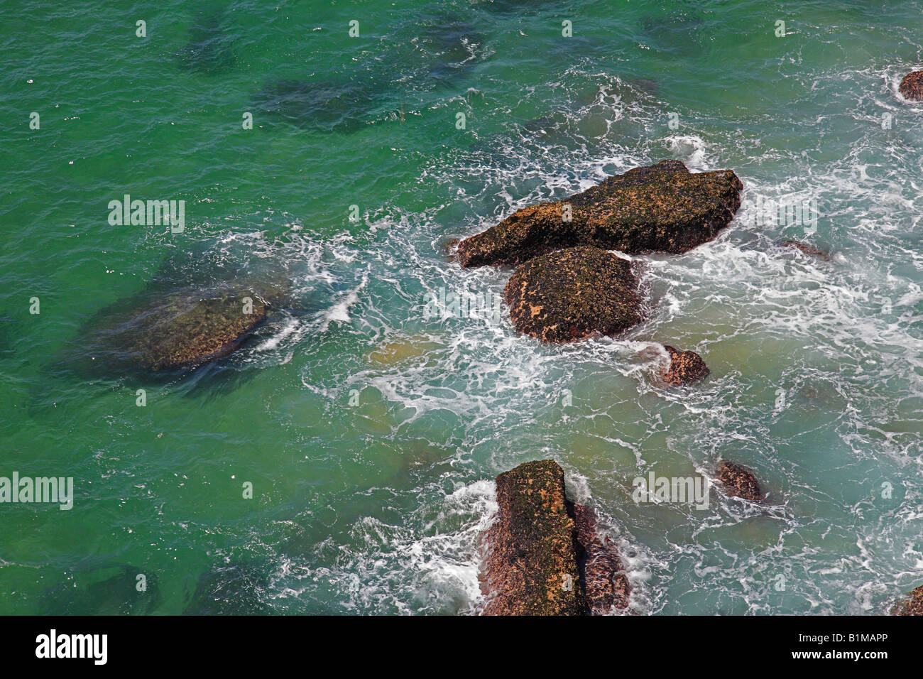 Waves rushing over rocks Stock Photo - Alamy