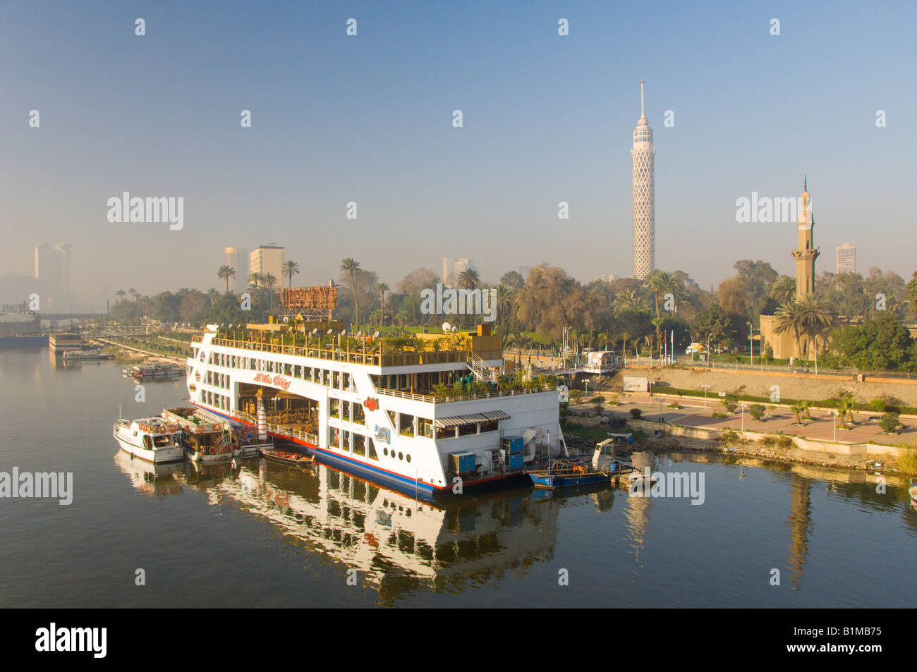 Early morning reflections on the Nile River with a riverboat restaurant ...