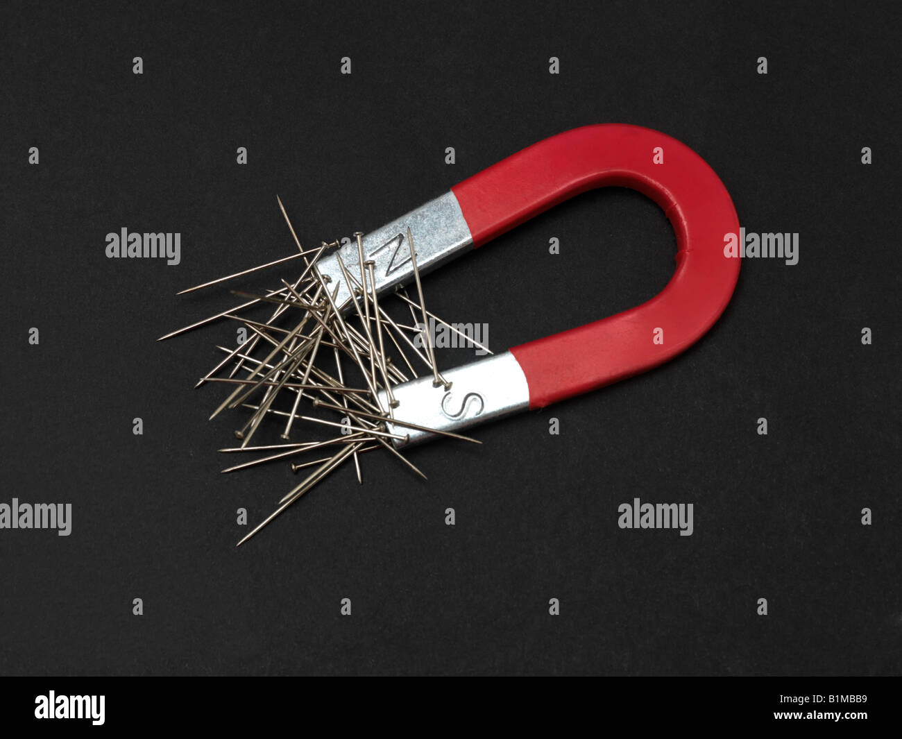 Horse shoe Magnet Picking up Pins Stock Photo - Alamy