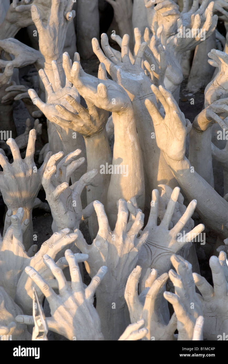 Concrete cement hands reaching up from the ground Stock Photo - Alamy