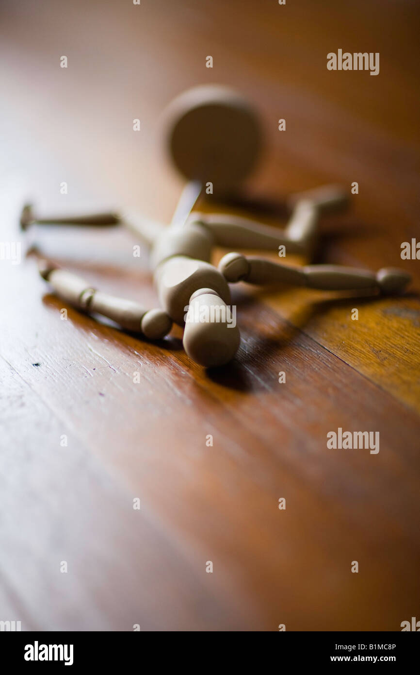 A Fallen Drawing Figurine on Wood Floor Stock Photo - Alamy