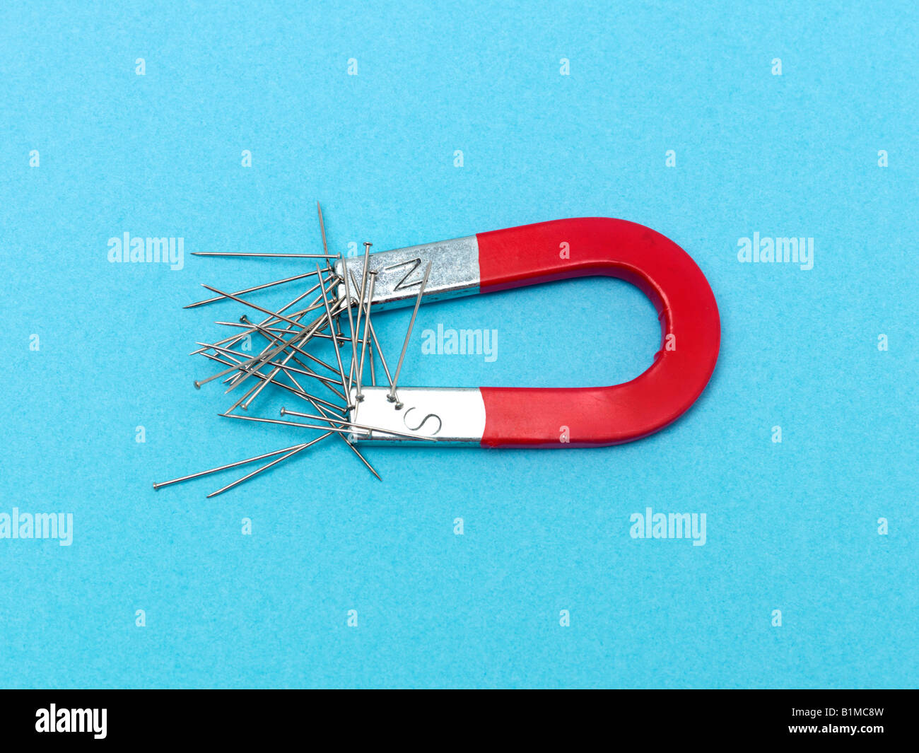 Horse shoe Magnet Picking up Pins Stock Photo - Alamy