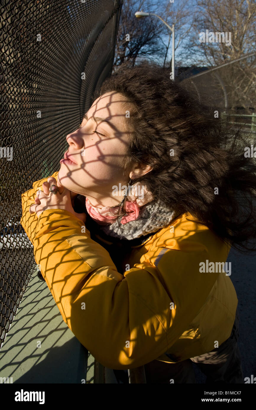Teenage girl thinking things over while getting some sun in Brooklyn ...