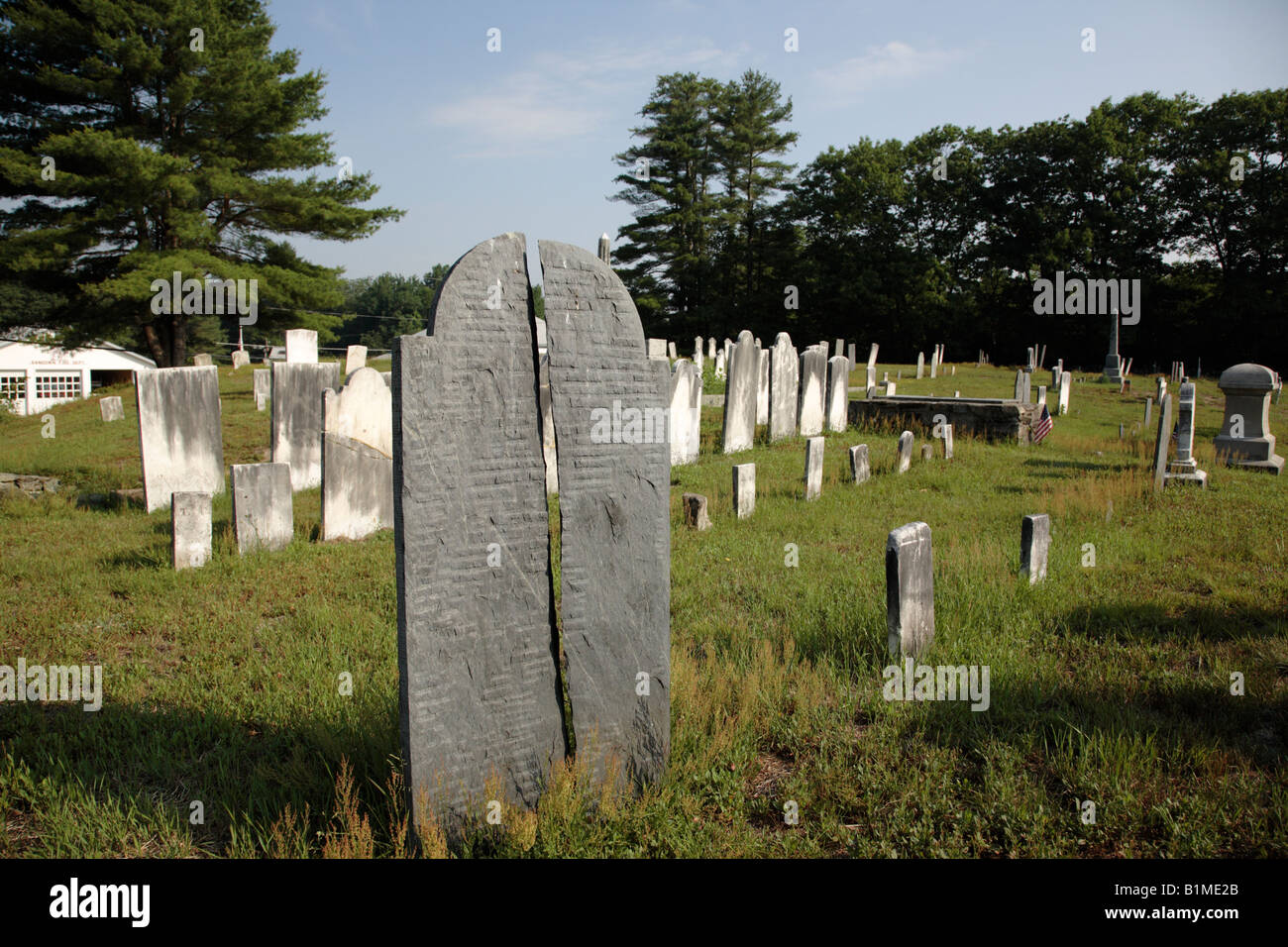Cracked headstone in a New England graveyard Stock Photo - Alamy