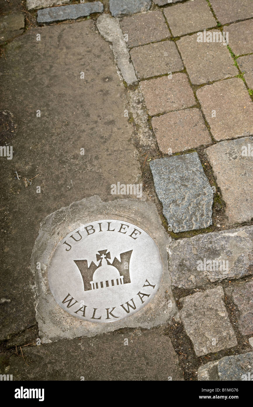 Metal roundels set in paving about 12 inches in diameter marking the ...