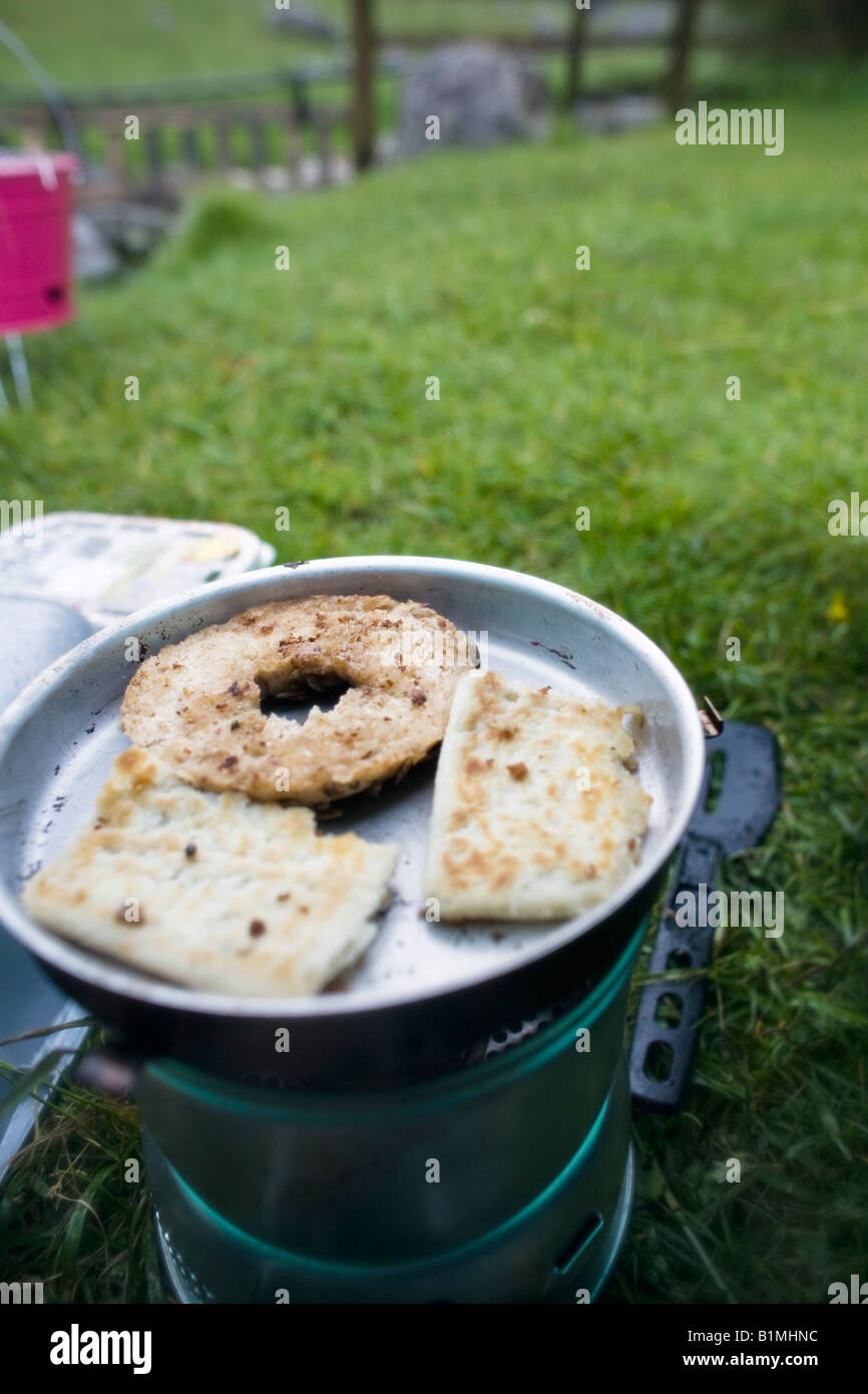 camping cooking breakfast on trangia. Bagels and potatoe scones ...