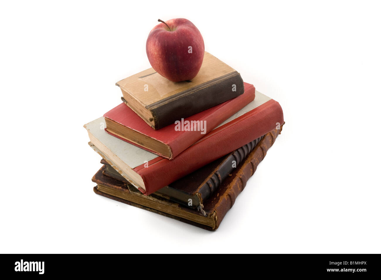 red apple on old books isolated on white Stock Photo - Alamy