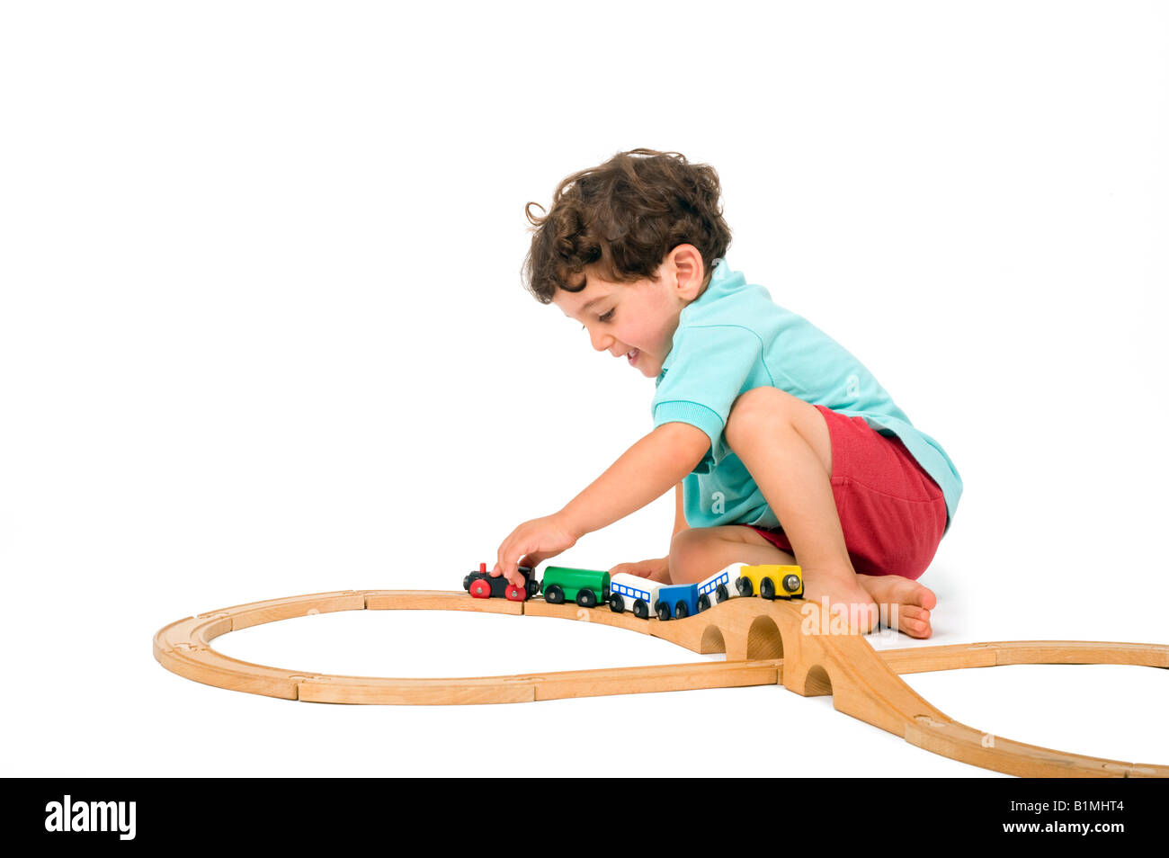 little boy playing with toy train isolated on white Stock Photo - Alamy