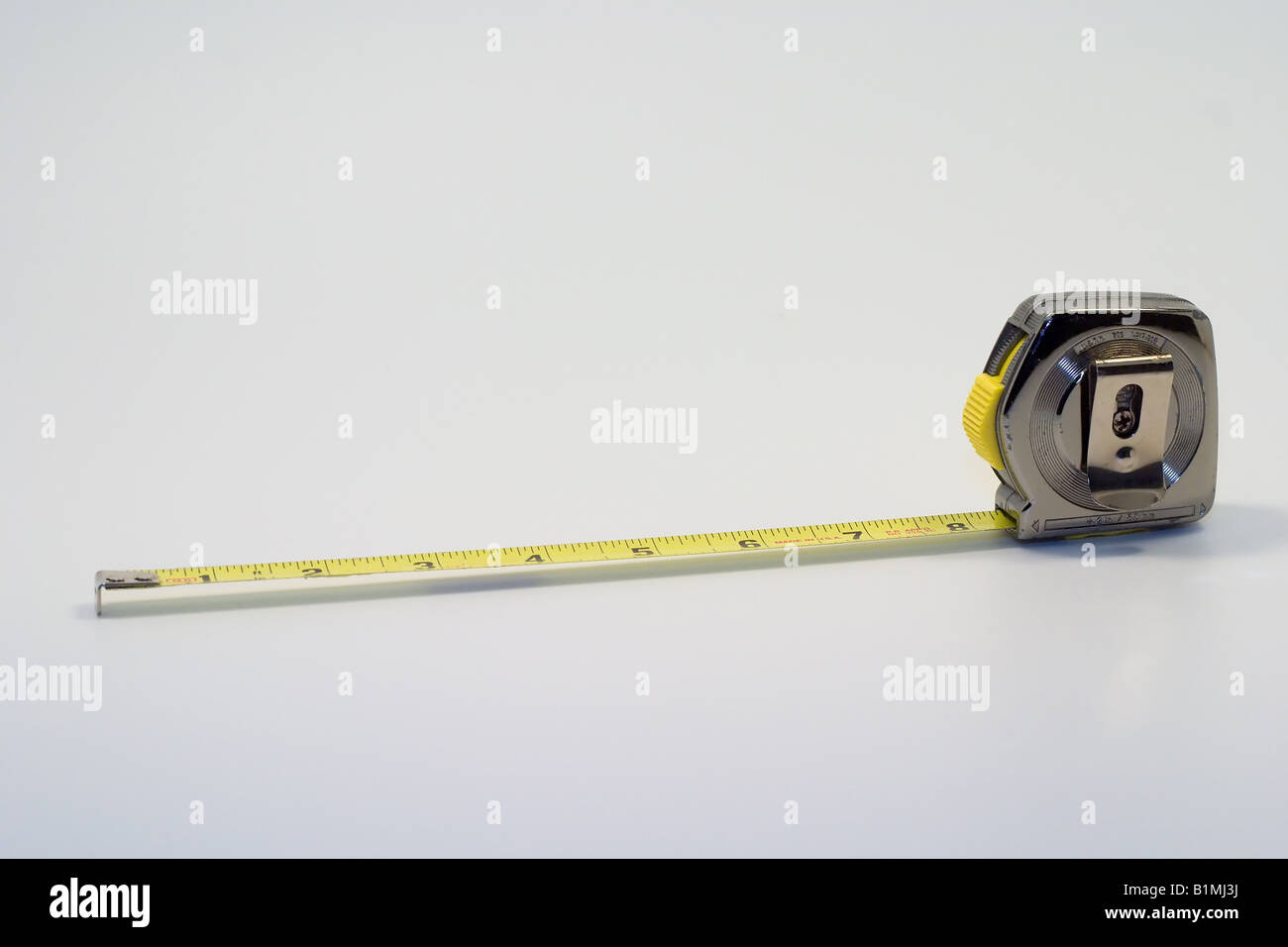 Tape measure with yellow tape extended Stock Photo - Alamy