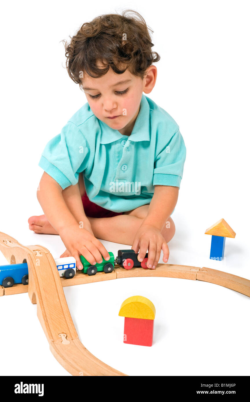 little boy playing with toy train isolated on white Stock Photo - Alamy