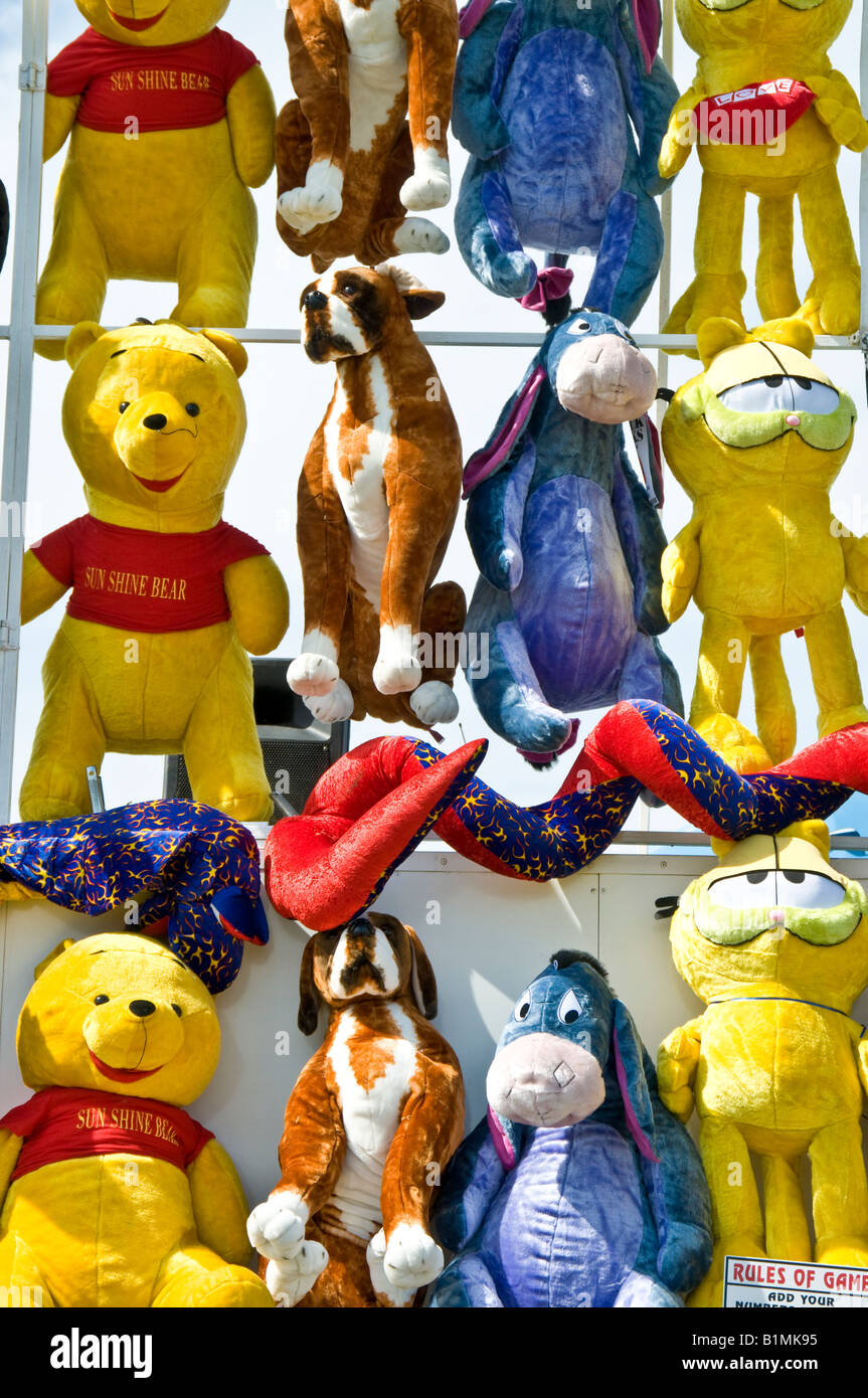 stuffed toy cartoon characters being offered as prizes at a fairground ...