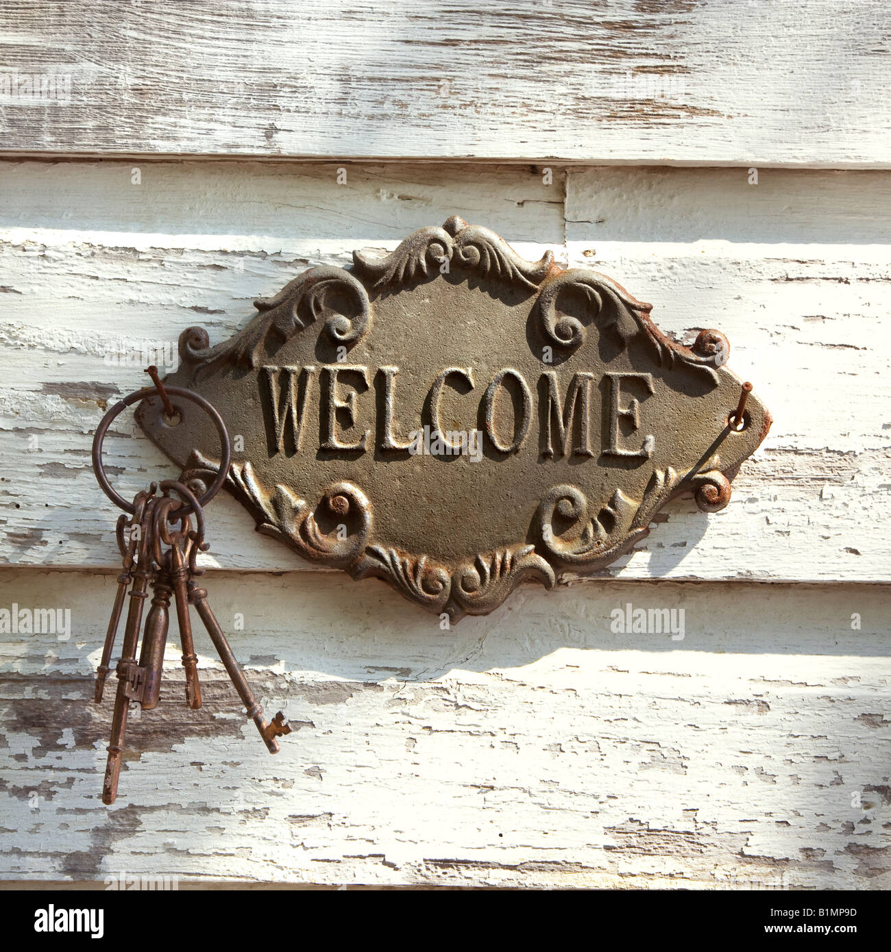 Welcome sign and metal keys on old white peeling building Stock Photo ...