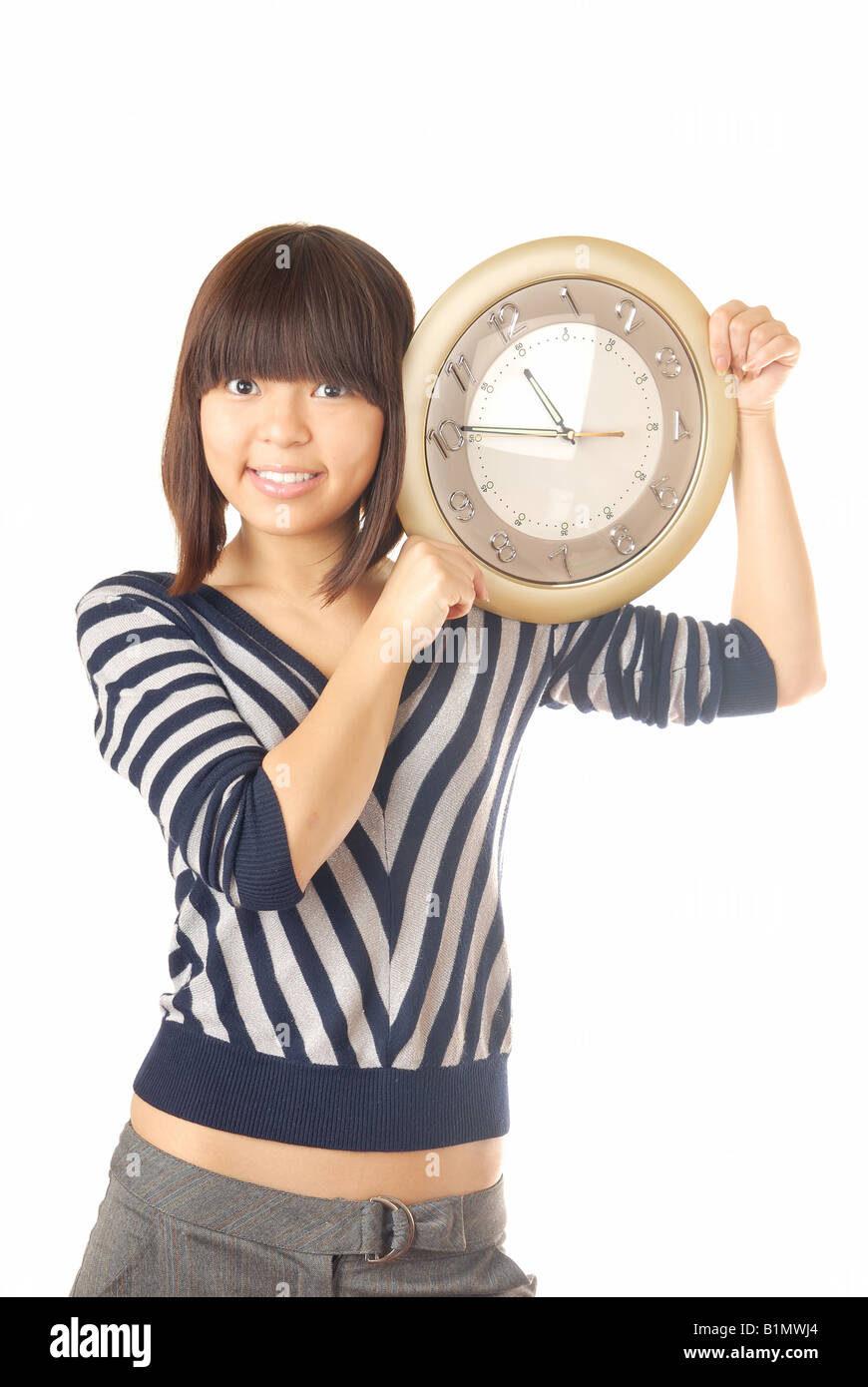 Photo of the smiling lady holding the clock Stock Photo - Alamy